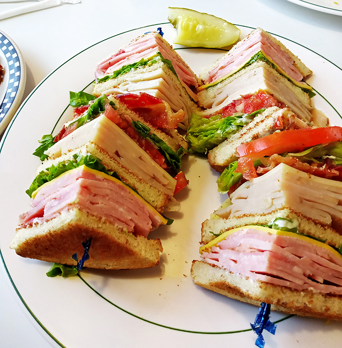 The club sandwich&mdash;a skyscraper of deli meat architecture that requires both hands, several napkins, and absolutely no regrets.