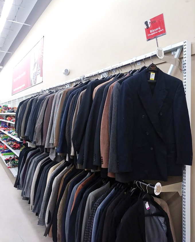 A wall of blazers waiting patiently, each one formerly owned by someone who definitely meant to lose those ten pounds.
