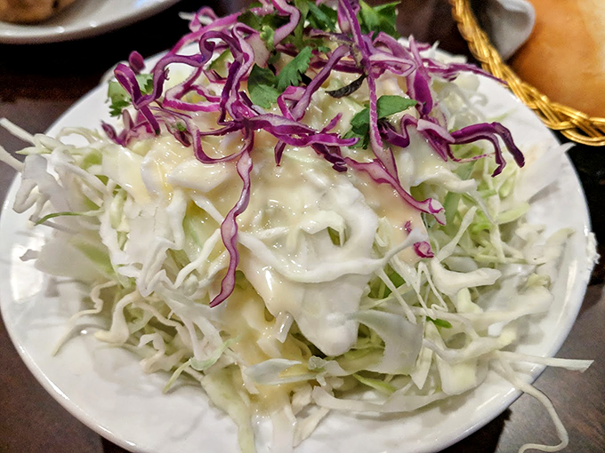 Coleslaw that refuses to be a mere side dish&mdash;crisp cabbage dressed in creamy goodness and topped with vibrant purple accents like confetti at a celebration.