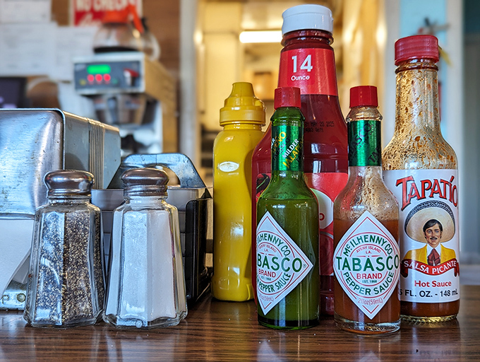 The condiment lineup&mdash;where every hot sauce bottle tells a story of meals transformed from good to "I need a moment alone."