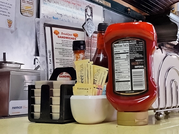 The condiment station &ndash; where ketchup is king and those little packets of sweetener have been organizing themselves by color since 1973.
