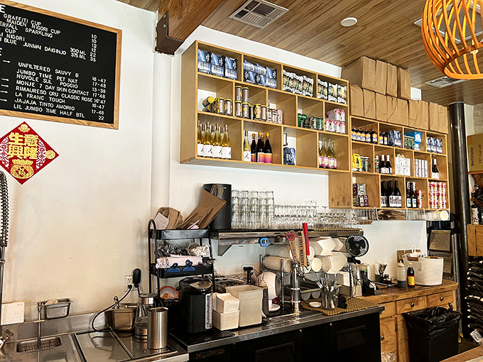 Behind the counter is where the magic happens. Shelves stocked with carefully curated teas and wines—evidence that what you drink deserves as much attention as what you eat.