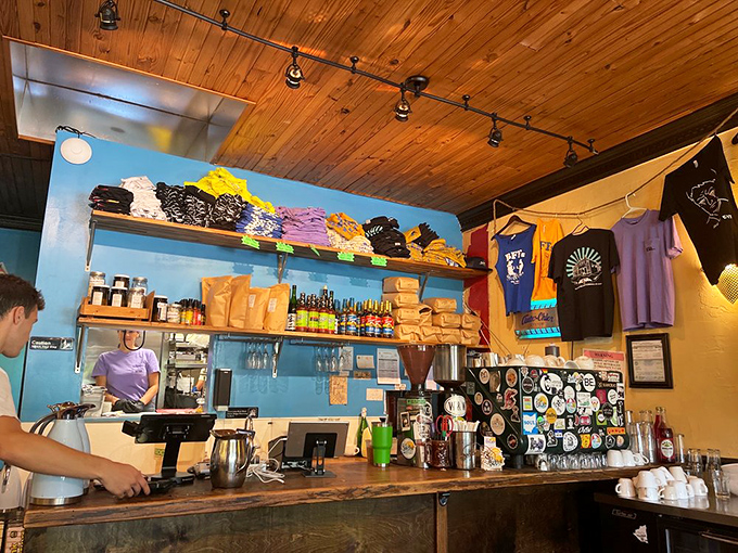 The counter area doubles as a mini merchandise museum, where coffee and t-shirts coexist in caffeinated harmony.