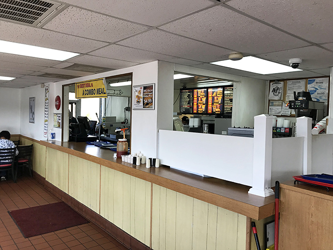 Yellow wood paneling and straightforward service counter—like stepping into a burger joint time capsule that thankfully never got the memo about modernizing.