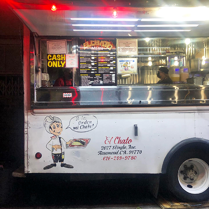 Behind the counter, where magic happens nightly. The taquero's concentration is the focus of an artist at work.