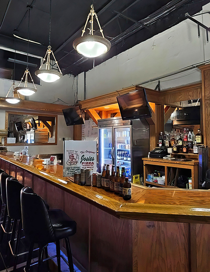 The bar area&mdash;where cold beer meets hot pizza in a romance as old as time itself. Wood paneling included at no extra charge.