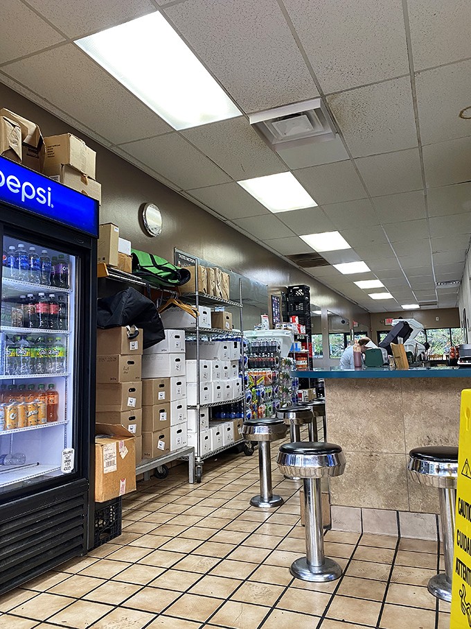 Behind the scenes, the kitchen crew orchestrates controlled chaos while customers eagerly await their paper-wrapped prizes.