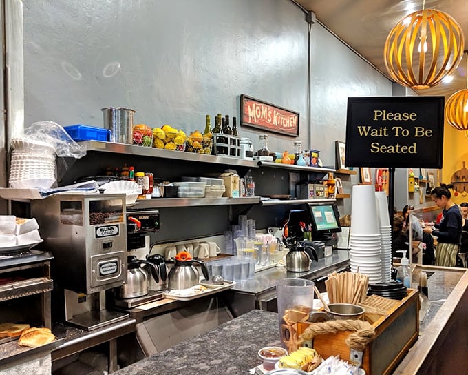 The counter view: where coffee cups are always full, orders fly, and the breakfast symphony plays its daily sold-out performance.