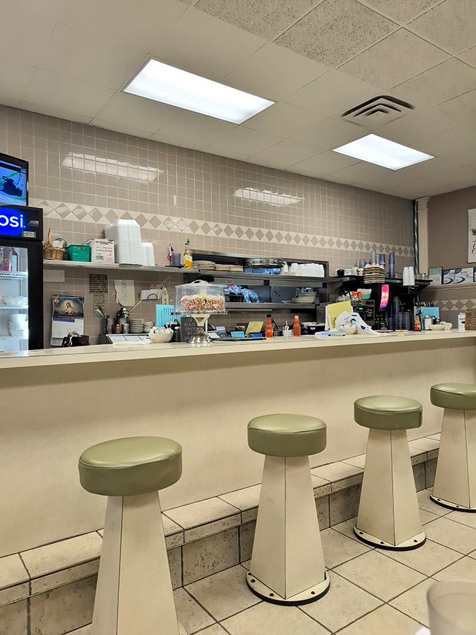 Counter seating: where solo diners become regulars and the coffee refills flow like conversation. Prime real estate for food voyeurs.