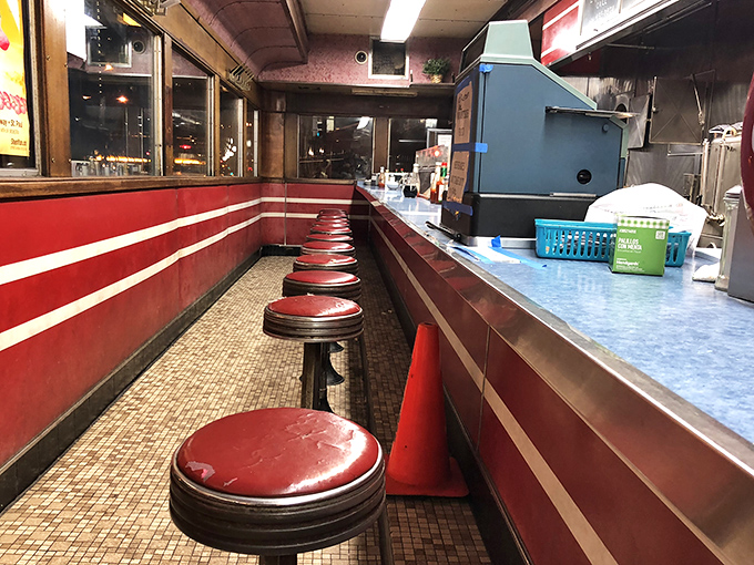 The counter at Mickey's stretches like a red vinyl runway, each stool a front-row seat to the short-order ballet that's been performed daily since 1939.