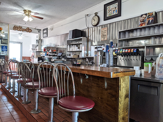 The wood-paneled counter gleams with decades of elbow polish, a testament to countless arms leaned in anticipation of burrito bliss.