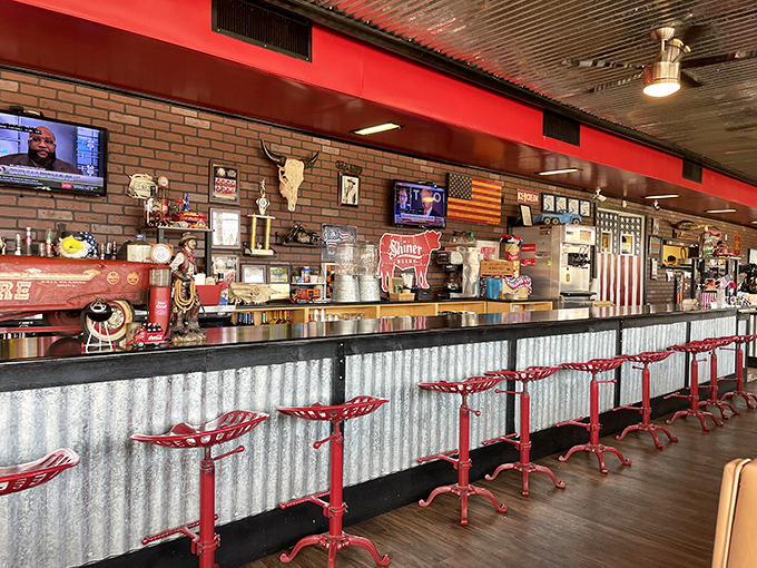 The counter stretches long with corrugated metal, vintage Americana, and red stools inviting you to belly up.
