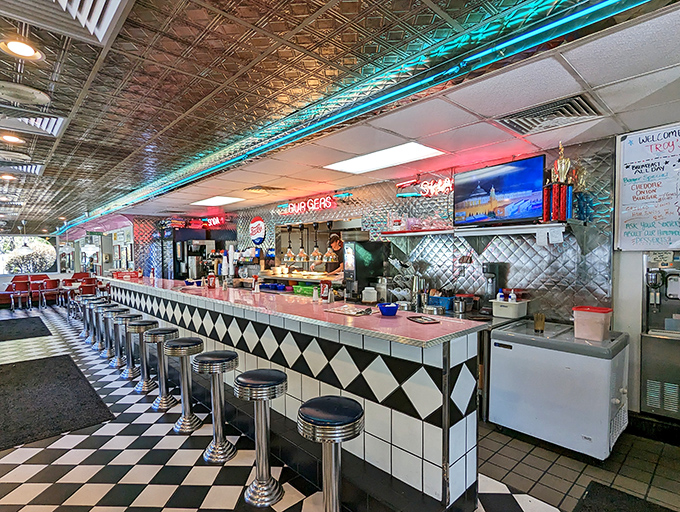 The counter offers front-row seats to the short-order ballet, where the black and white checkered floor plays chess with your diet plans.