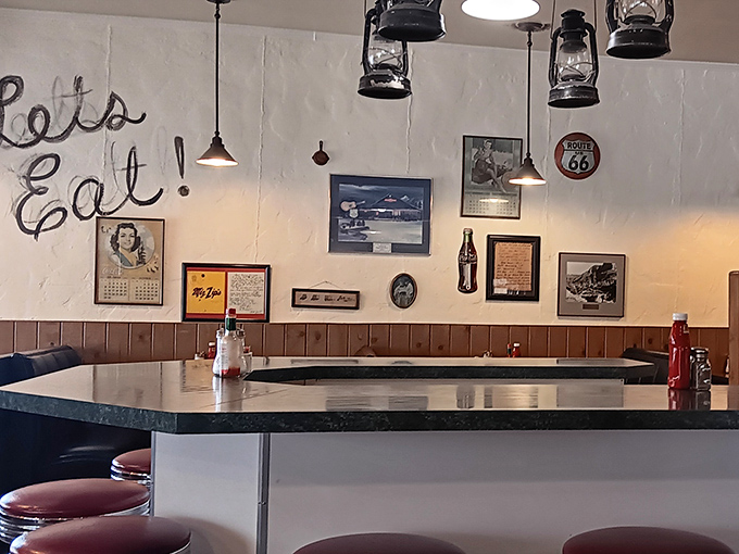 "Let's Eat!" indeed. The counter seating area whispers promises of blue-ribbon diner fare while vintage lanterns cast their approving glow.