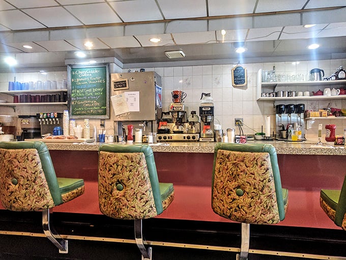 Classic diner counter seating with vintage-inspired chairs invites solo diners to enjoy coffee and conversation with friendly staff.