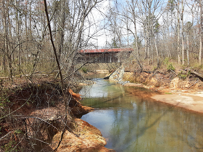 The bridge's reflection in Lyles Creek creates a perfect symmetry—history above, nature below, both flowing together through time.