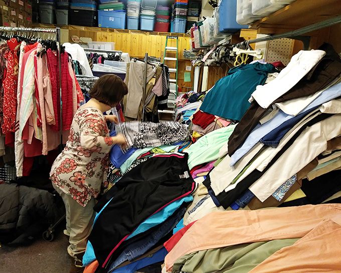 Treasure hunting is serious business, as this shopper demonstrates while diving into mountains of potential wardrobe additions.