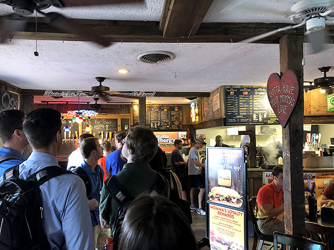 The line forms with the precision of game day formations—students and locals united by the universal language of sandwich cravings.