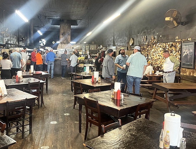 The dining room fills with barbecue devotees making their pilgrimage. Notice how conversation pauses when the first bite hits&mdash;that's respect in action.