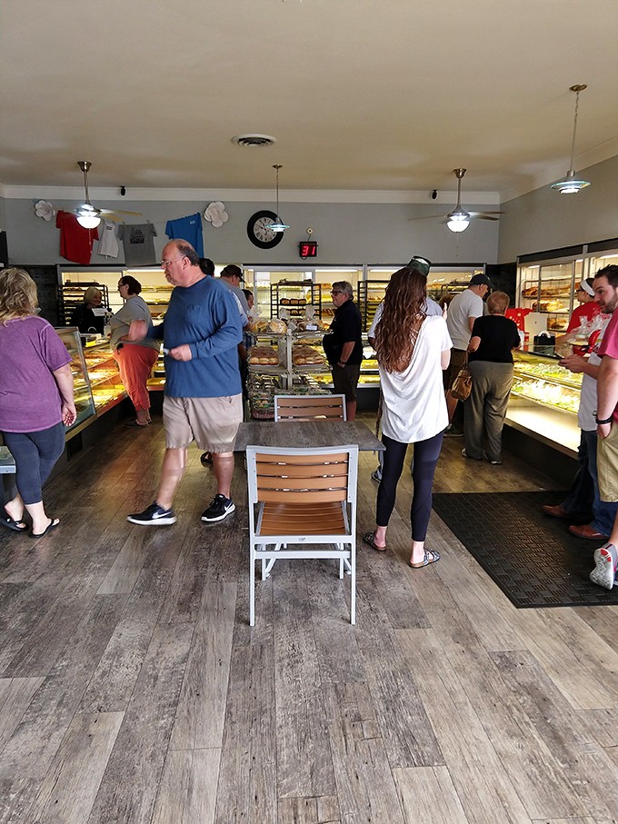 The bakery dance: customers shifting weight from foot to foot, mentally calculating how many donuts they can reasonably claim are "for the office."