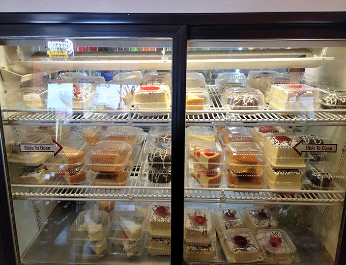 The dessert case stands like a museum of sweet temptations, each plastic container housing a masterpiece of Mexican confectionery.