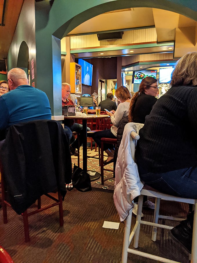 A bustling evening at Grotto where strangers become neighbors over shared food experiences. The colorful archway frames more than just the room&mdash;it frames memories.