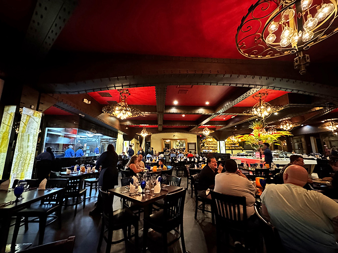 The restaurant buzzes with conversation under dramatic red ceilings. Everyone's united by the universal language of "pass the meat, please."