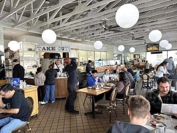 Where breakfast dreams come true&mdash;patrons gather at wooden tables while staff work their morning magic behind the counter.