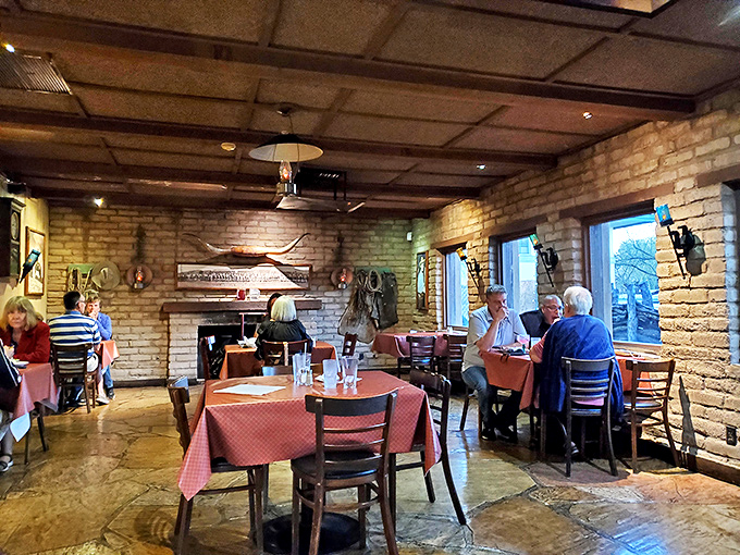 Stone walls and wooden beams frame a dining room where conversations have flowed as smoothly as the wine for generations of Tucson families.
