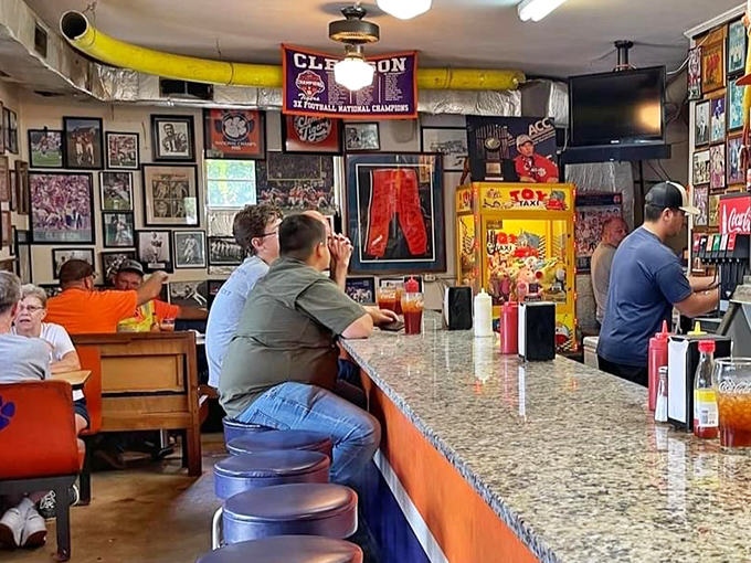 Where strangers become neighbors over sweet tea and shared tables, surrounded by decades of Clemson victories immortalized on the walls.