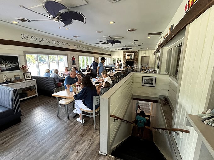Diners enjoying their meals in a space where ceiling fans and coordinate markers set the perfect maritime mood.