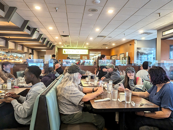 Where strangers become temporary family, united by the universal language of "pass the ketchup" and satisfied sighs.