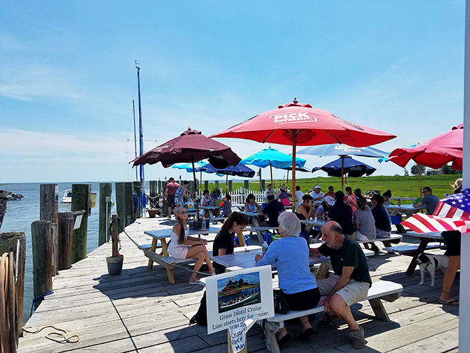 Waterfront dining at its most democratic &ndash; colorful umbrellas, simple tables, and the shared joy of fresh seafood by the harbor.