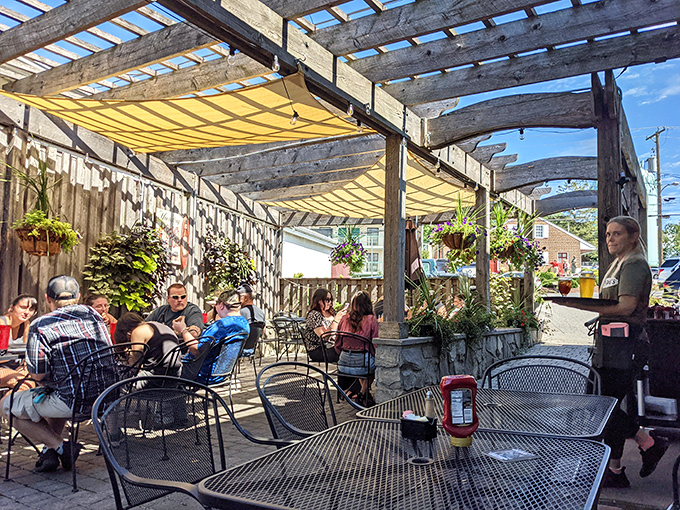 The outdoor patio creates a perfect retreat for enjoying Pennsylvania summer days, with rustic wooden beams providing just enough shade for comfort.