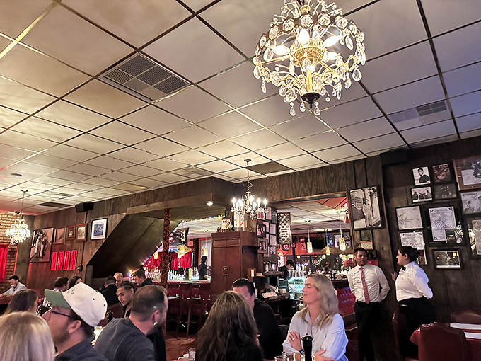 A packed house of happy diners under crystal chandeliers. Notice nobody's looking at their phones&mdash;that's the power of great food.