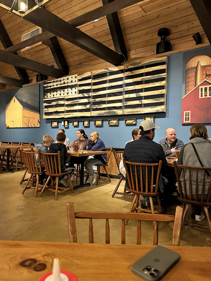 Beneath wooden beams and American flag art, diners engage in the serious business of enjoying food that requires no serious conversation.