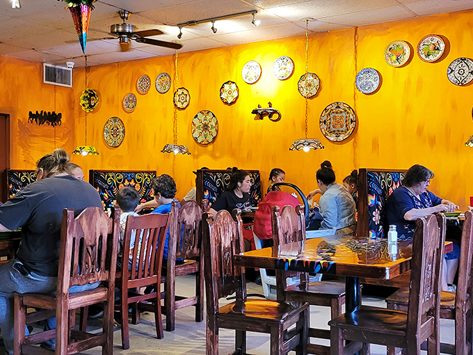 The dining room hums with the universal language of good food&mdash;colorful plates against warm yellow walls creating a canvas for culinary memories.