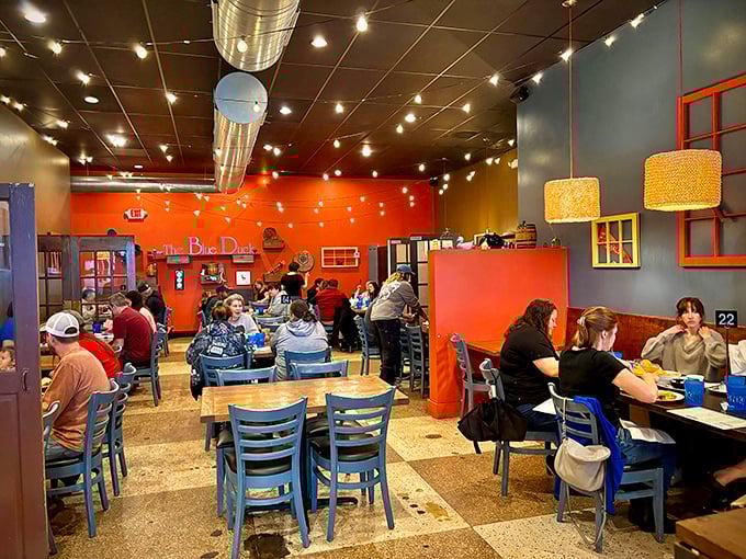 A bustling interior where coral walls and string lights create the perfect backdrop for food that demands to be photographed.