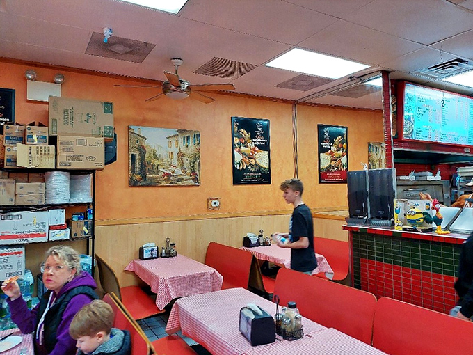 The dining room tells the real story&mdash;families and friends gathered around red-checkered tables, participating in the universal ritual of breaking bread together.