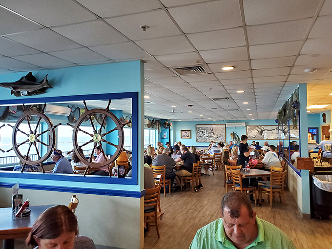 Ship wheels frame diners like maritime portraits&mdash;"Family Enjoying Seafood, 2023," a masterpiece of Biloxi dining culture.