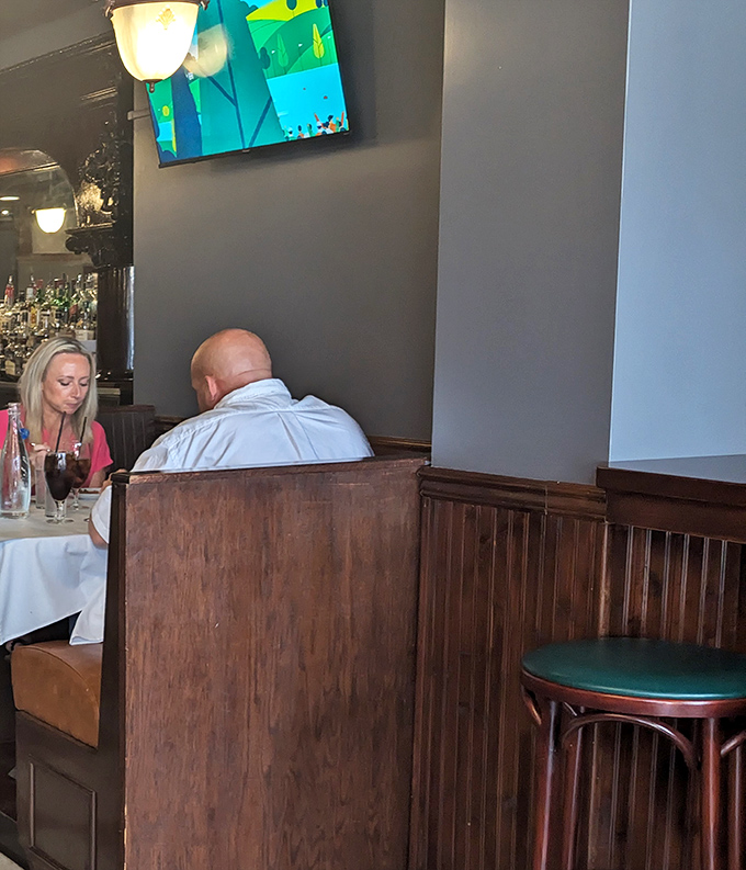 A glimpse of diners enjoying their evening reminds us that great restaurants aren't just about food&mdash;they're about creating spaces where memories are made.