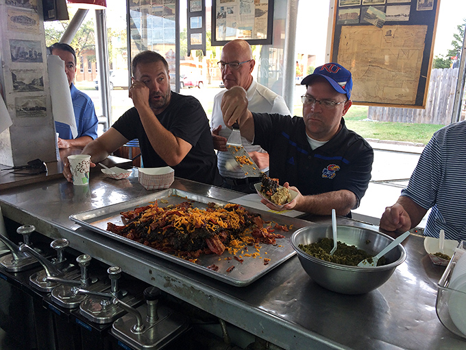 The universal language of good food brings strangers together. These gentlemen aren't just eating lunch—they're participating in a Kansas tradition.