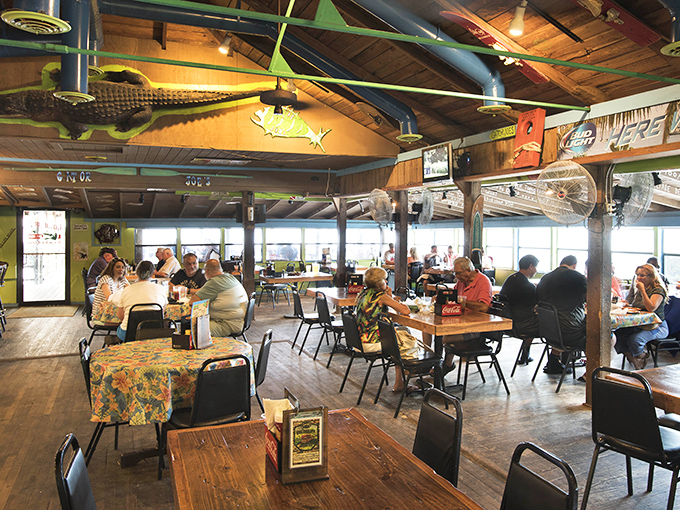 Tables filled with happy diners under wooden beams—proof that good food brings people together better than any social media platform ever could.