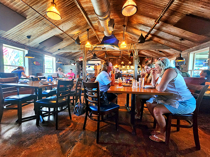 Sunlight streams through windows illuminating happy diners in Fishcamp's warm, wood-lined interior. It's the kind of place where vacation memories are made between bites of fresh-caught seafood.