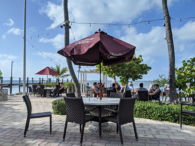 Umbrella-shaded tables offer front-row seats to paradise, where lunch comes with a side of breathtaking bay views.