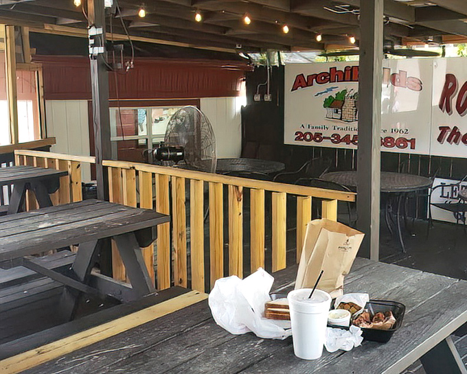 Simple tables, crimson chairs, and a TV likely showing the Tide &ndash; the perfect setting for a barbecue pilgrimage.