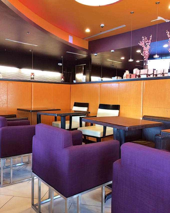The dining area's warm orange and purple color scheme feels like the designers understood exactly what comfort food deserves.