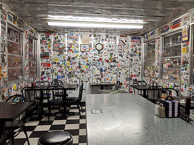 The dining area feels like a museum of American pop culture, where every sticker and photo represents someone who once sat exactly where you're sitting now.