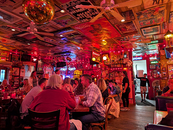 The crimson glow bathes diners in flattering light while the ceiling's collage of memorabilia provides endless conversation starters between bites.