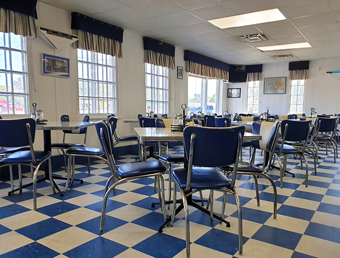 Blue chairs against checkerboard floors create that classic American diner aesthetic where conversations flow as freely as the coffee.